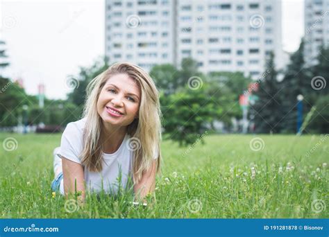 Portrait Of A Beautiful Girl In Denim Shorts And A White T Shirt Stock