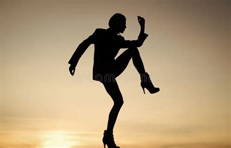 Female Silhouette On Sunset Sky Background Of Dancing Woman Silhouette