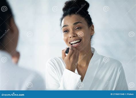 Happy Beautiful Millennial Black Girl Putting On Lipstick Rouging Lips