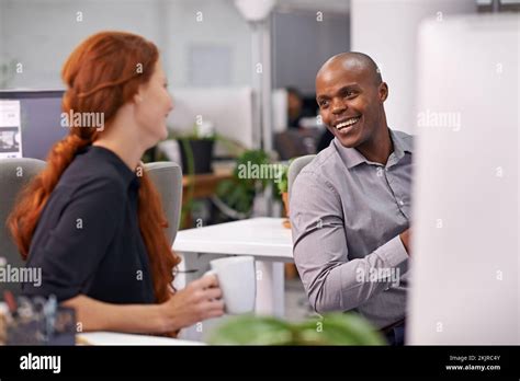 Making Friends In The Office Two Colleagues Sharing A Laugh In The
