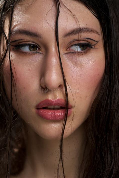 The Face Of A Beautiful Young Girl With Wet Black Hair Close Up