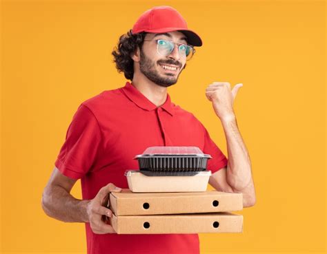 Free Photo Smiling Delivery Man In Red Uniform And Cap Wearing