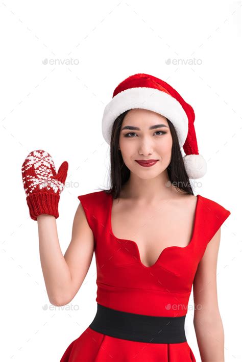Portrait Of Beautiful Asian Woman In Santa Costume And Mitten Waving