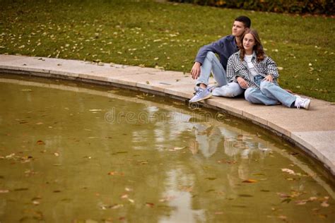 Young Couple Kissing And Rejoices At The Lake Lovely Young Couple