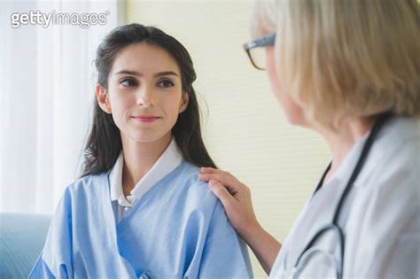 The Doctor Takes Care Of The Female Patient While She Sitting On The