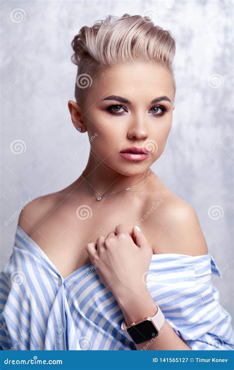 Closeup Blonde Model With Bright Make Up Bare Shoulders And Short Hair