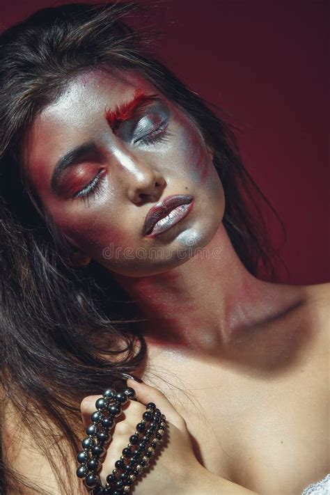 Fashion Portrait Of A Dark Skinned Girl With Silver Foil Make Up