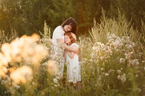 Premium Photo Mother Gently Hugs Her Daughter In Nature On A Summer