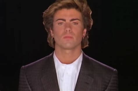 The Man Is Wearing A Suit And White Shirt