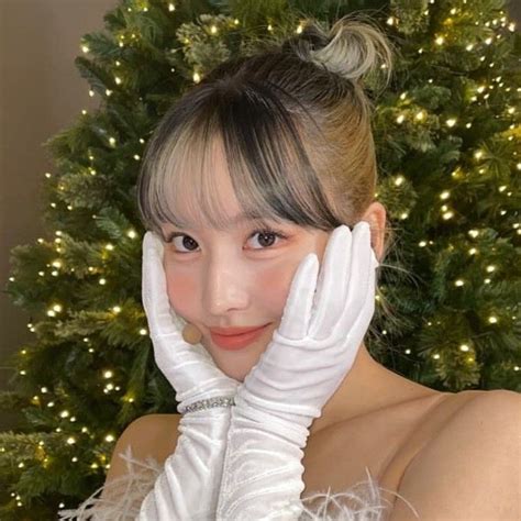 A Woman Wearing White Gloves And Holding Her Hands To Her Face In Front