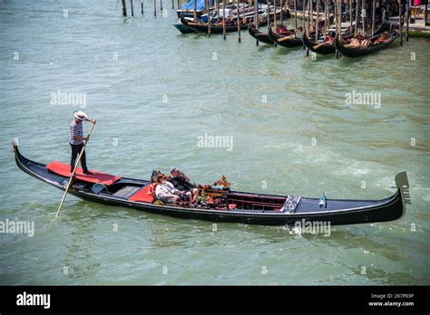 A Couple Exploring The Grand Canal On A Gondola In Venice Italy Stock