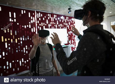 computer programmers testing virtual reality simulator glasses stock