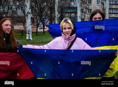 Women Gather By The Side Of The Road With Ukrainian Flags To Encourage
