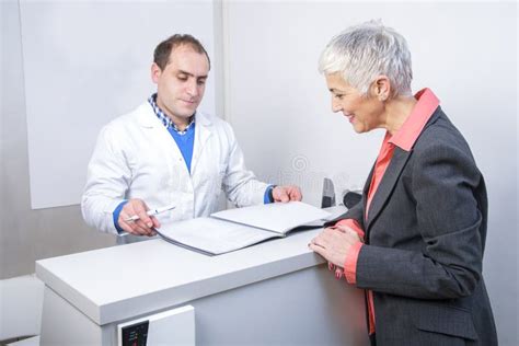 Happy Older Lady Paying Her Medical Bill Stock Image Image Of Cost