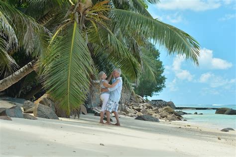 Premium Photo Happy Elderly Couple Dancing On Tropical Beach