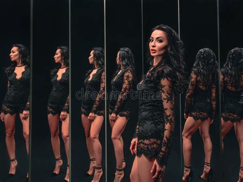 Portrait Of Beautiful Brunette Woman Standing Near The Mirrors Stock