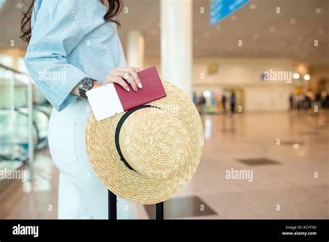 Closeup Of Woman Holding Passports And Boarding Pass At Airport Stock