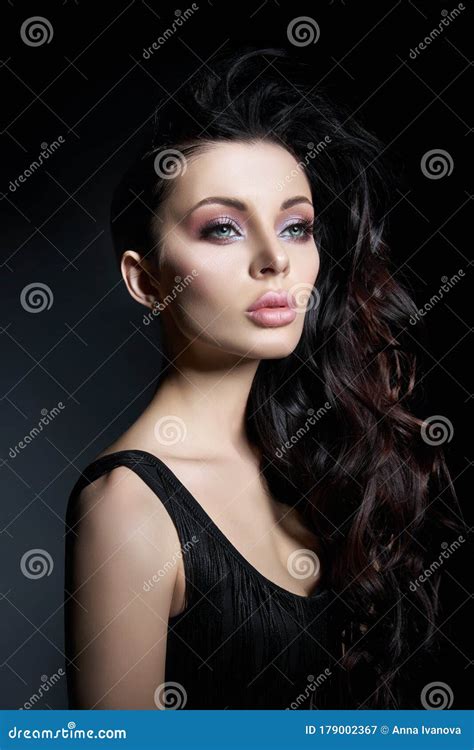 Portrait Of A Brunette Woman With A Chic Lush Wavy Hair Plump Lips