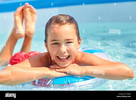 Relaxing Girl In Inflatable Swimming Circle In Swimming Pool Stock