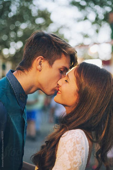 Young Couple Kissing At The Carnival By Jovana Rikalo Stocksy United