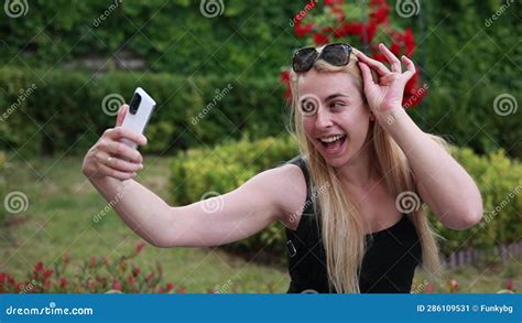 Blonde Woman Taking Selfies In The Park Video Stock Video Video Of