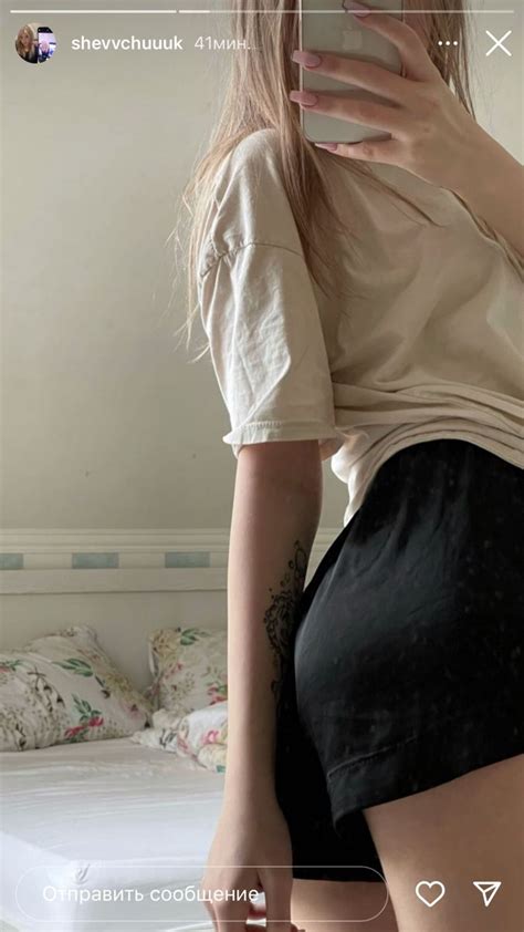 A Woman Is Taking A Selfie With Her Cell Phone While Standing In Front