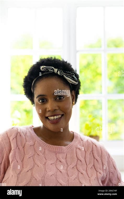 Portrait Of Happy Plus Size African American Woman By Window Stock