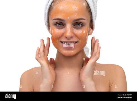 Beautiful Woman After Shower With Orange Cosmetic Mask On Her Face