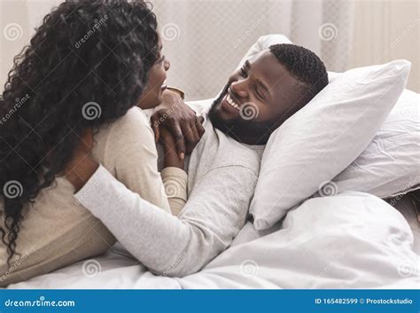 Portrait Of Romantic Black Couple Spending Time In Bed Together Stock