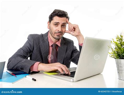 Attractive Businessman In Suit And Tie Working In Stress At Offi Stock