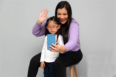 Single Divorced Latina Mom And Daughter Use Cell Phone To Video Call