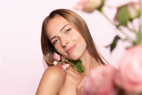 Spring Beautiful Young Girl With Glossy Blond Hair Holding Flower