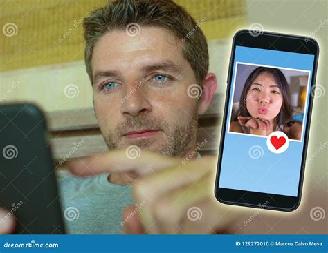 Young Handsome And Happy Man Using Internet Social Media On Mobile