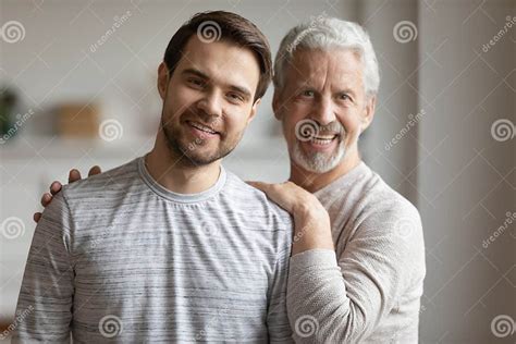 Portrait Of Happy Senior Father And Adult Son Hugging Stock Image