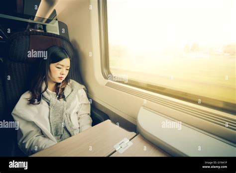 Beautiful Asian Girl Sleeping On The Train While Listening To Music