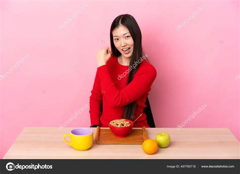 Young Chinese Girl Having Breakfast Table Celebrating Victory Stock
