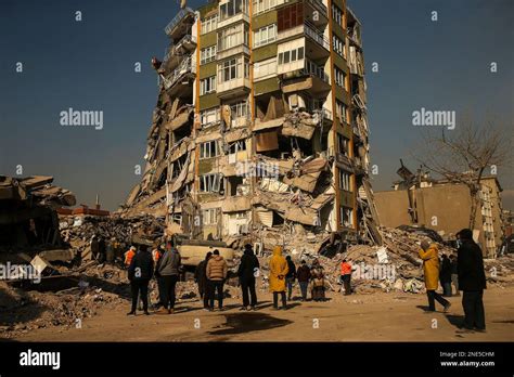 People Stand By A Collapsed Building In Kahramanmaras Southern Turkey