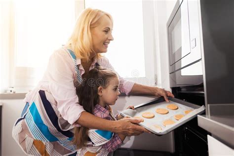 Grandmother Teaches Her Granddaughter How To Cook Homemade Muffins