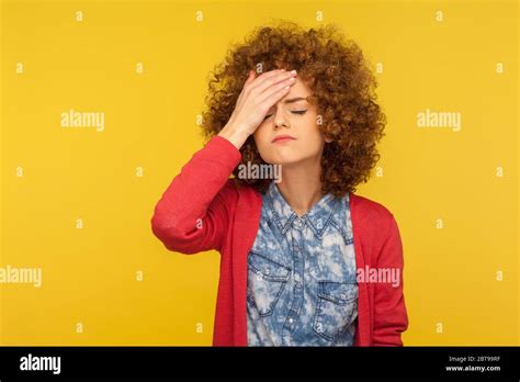 Facepalm Portrait Of Depressed Woman With Curly Hair Slapping Forehead