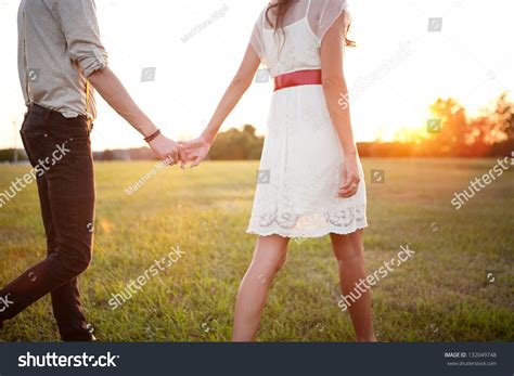 Couple Holding Hands Walking Away