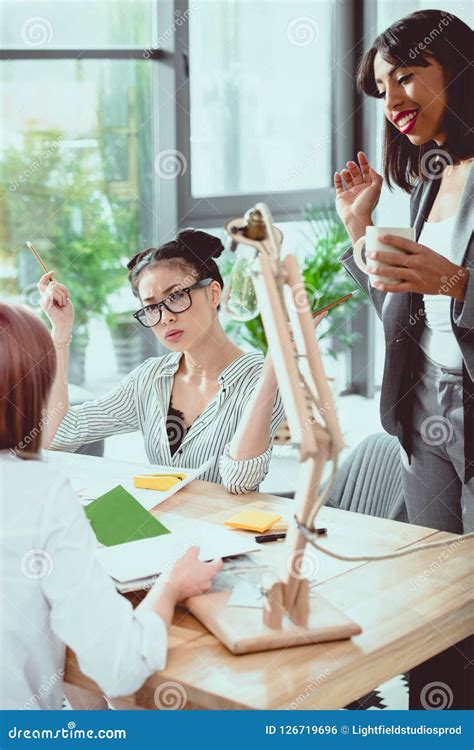 Professional Young Businesswomen Discussing While Working Together