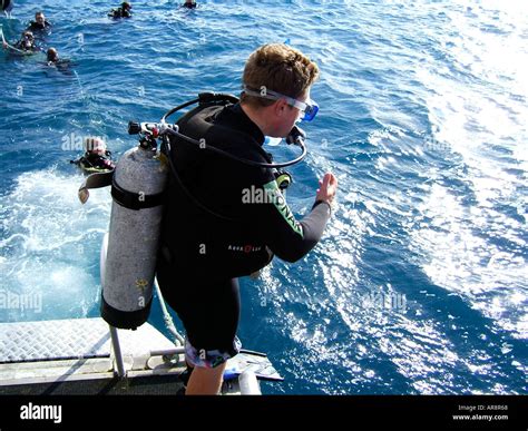 Scuba Diver Jumping Into The Water From A Dive Boat Coastal Waters