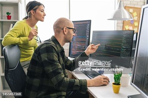 software programmers analyzing html code and database brainstorming