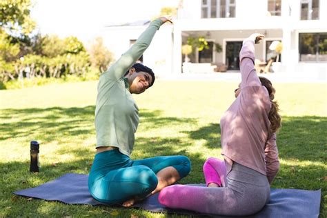 Premium Photo Happy Biracial Lesbian Couple Practicing Yoga Sitting