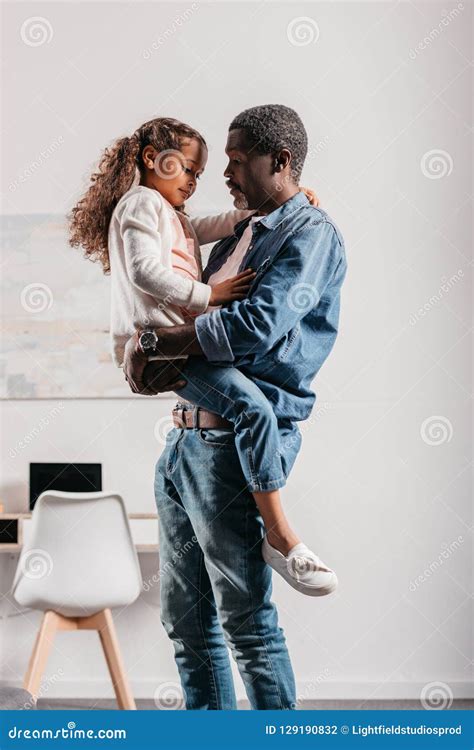 Loving African American Girl Embrace Father That Holding Her Stock