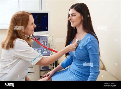 Doctor Listening Stethoscope With To Heart Of Young Female Patient