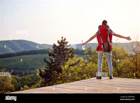 Young Woman Enjoying In Nature With Arms Spread At Viewpoint In