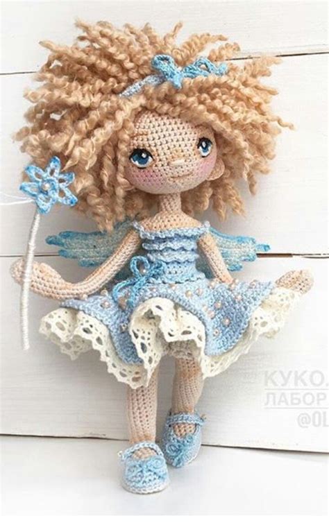 A Crocheted Doll With Blonde Hair And Blue Dress
