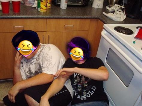 Two People With Smiley Face Masks Sitting On The Floor