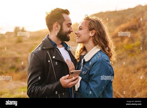 Beautiful Young Happy Stylish Couple Wearing Jackets Standing At The